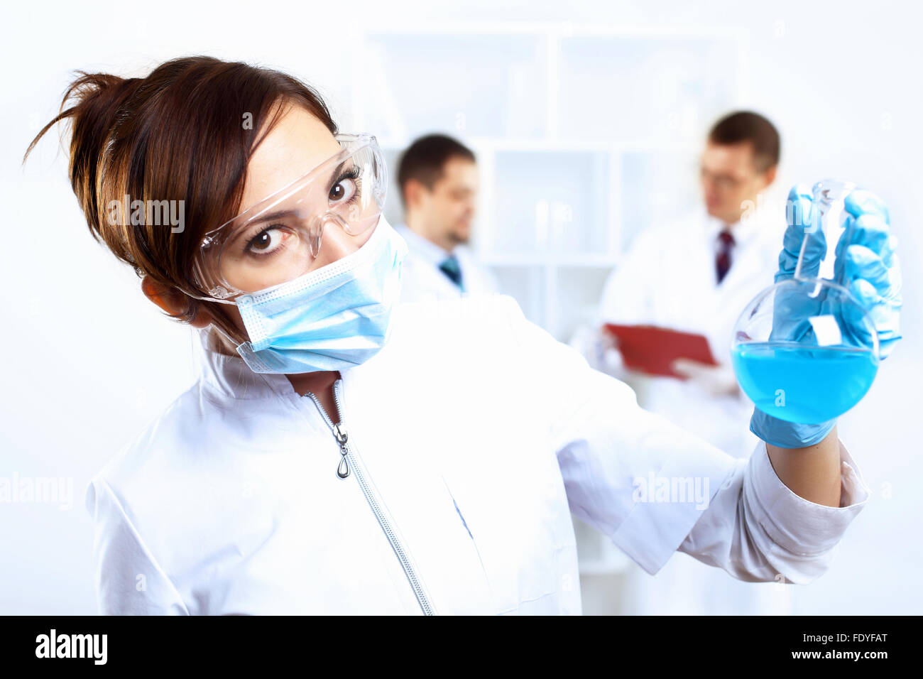 Scientist in uniform doing tests in laboratory Stock Photo - Alamy