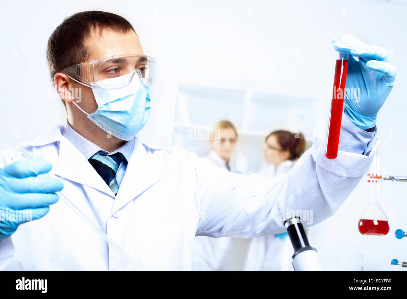 Scientist in uniform doing tests in laboratory Stock Photo - Alamy
