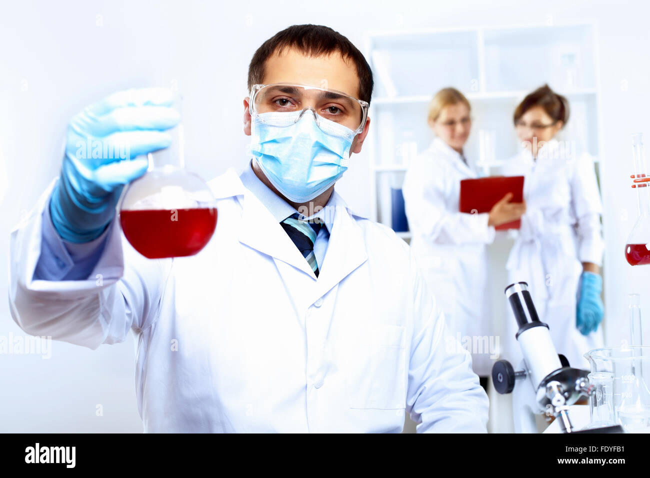Scientist in uniform doing tests in laboratory Stock Photo - Alamy