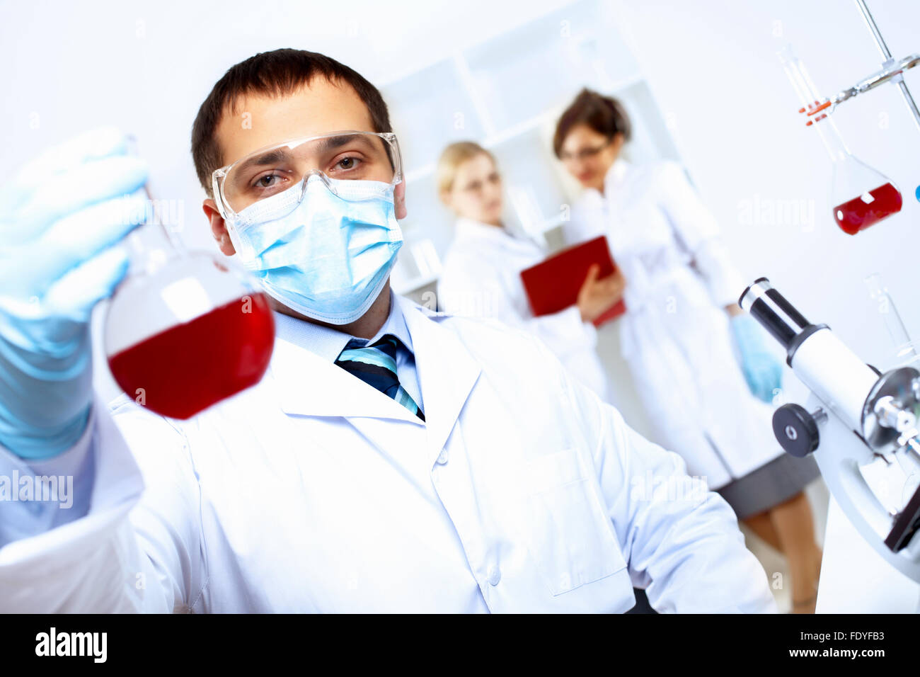 Scientist in uniform doing tests in laboratory Stock Photo - Alamy