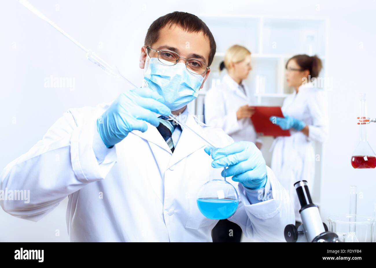 Scientist in uniform doing tests in laboratory Stock Photo - Alamy