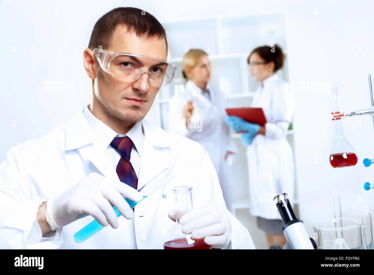 Scientist in uniform doing tests in laboratory Stock Photo - Alamy