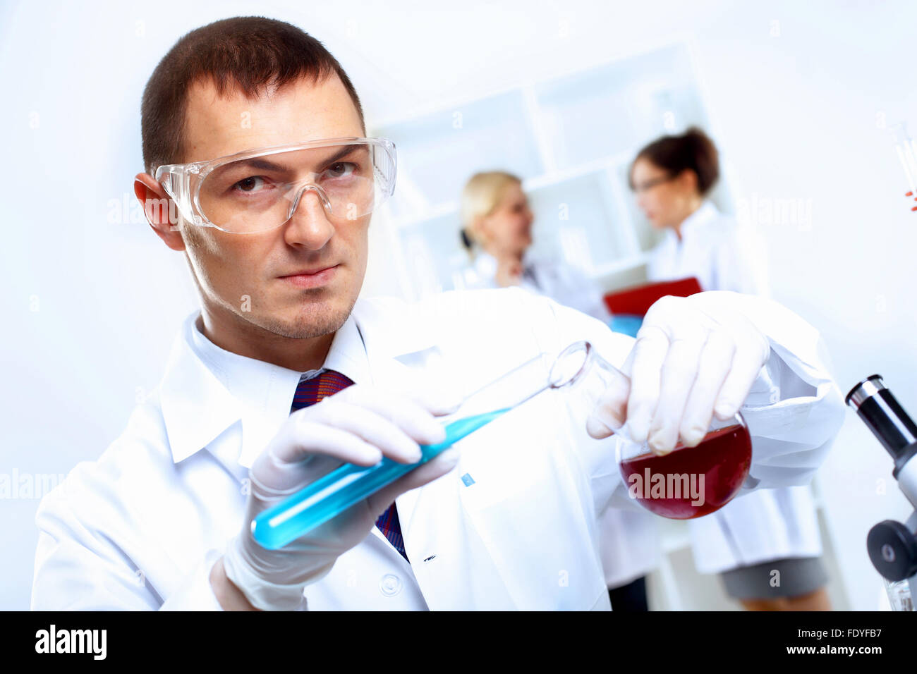 Scientist in uniform doing tests in laboratory Stock Photo - Alamy
