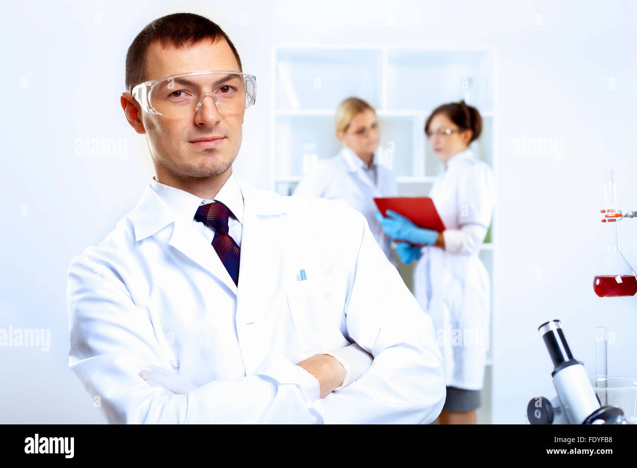 Scientist in uniform doing tests in laboratory Stock Photo - Alamy
