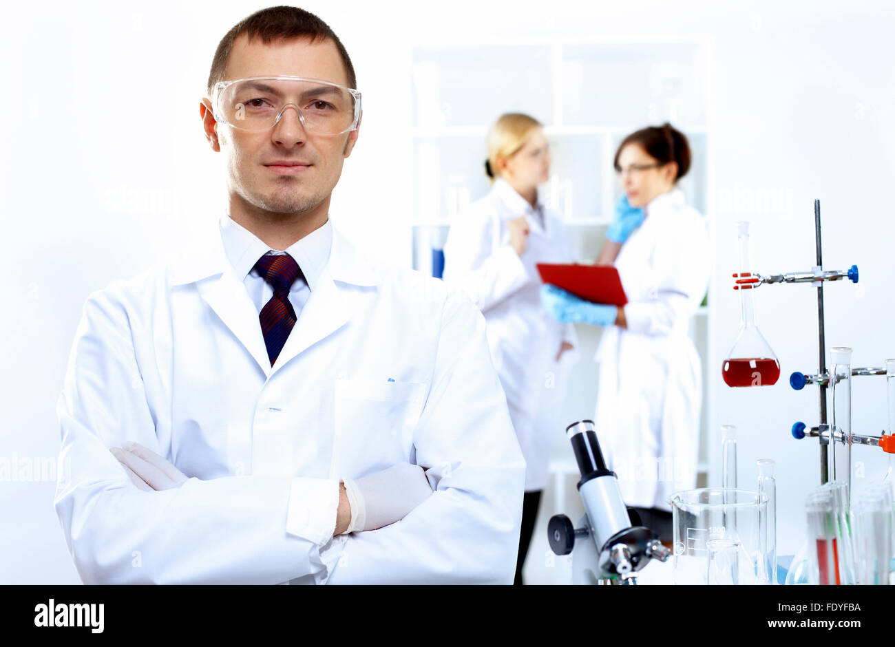 Scientist in uniform doing tests in laboratory Stock Photo - Alamy