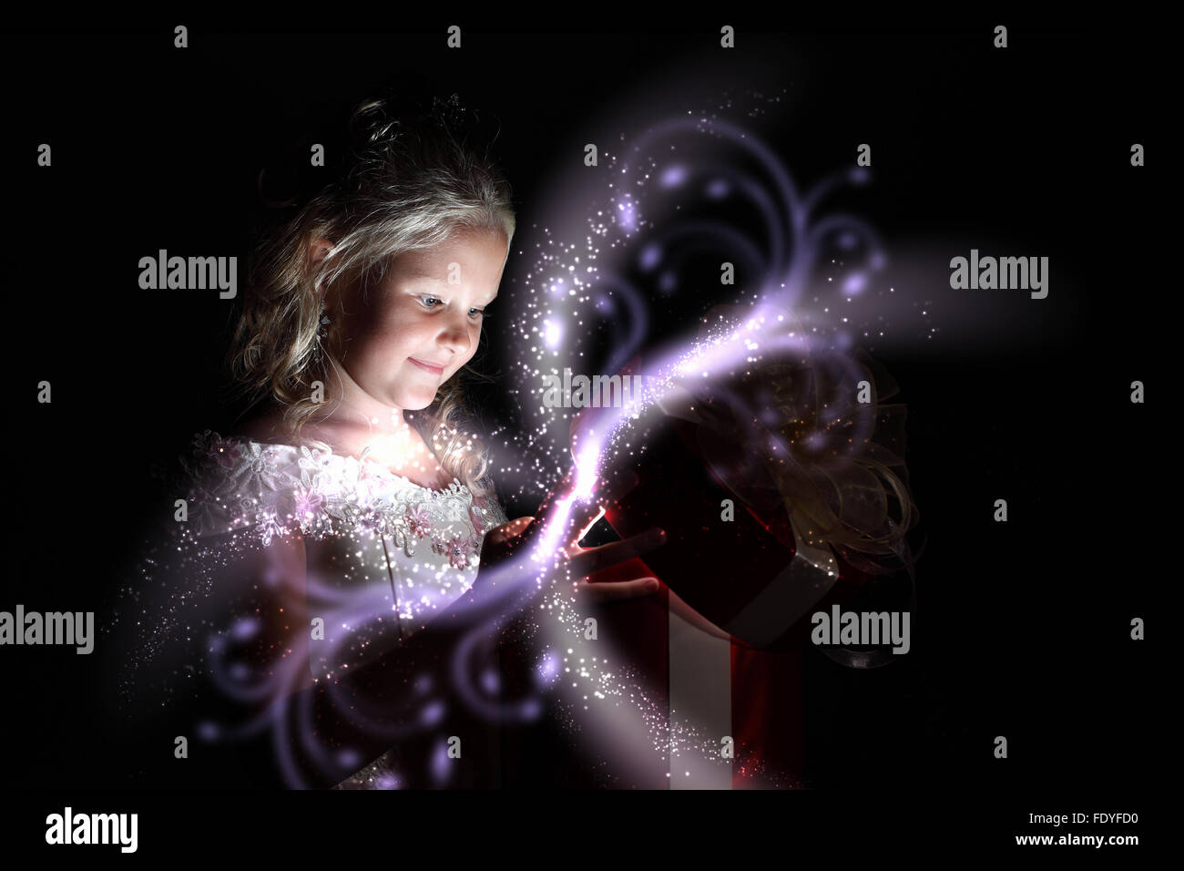 Child opening a magic gift box with lights and shining around Stock ...
