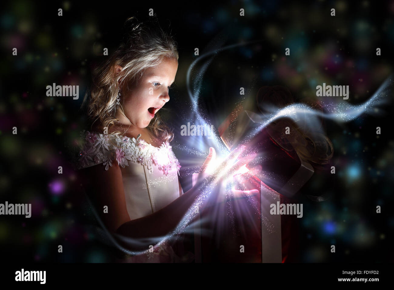 Child opening a magic gift box with lights and shining around Stock ...