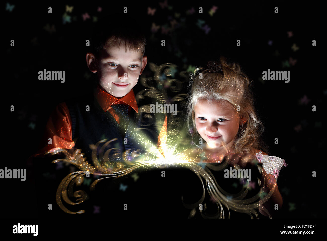 Children opening a magic gift box with lights and shining around Stock ...
