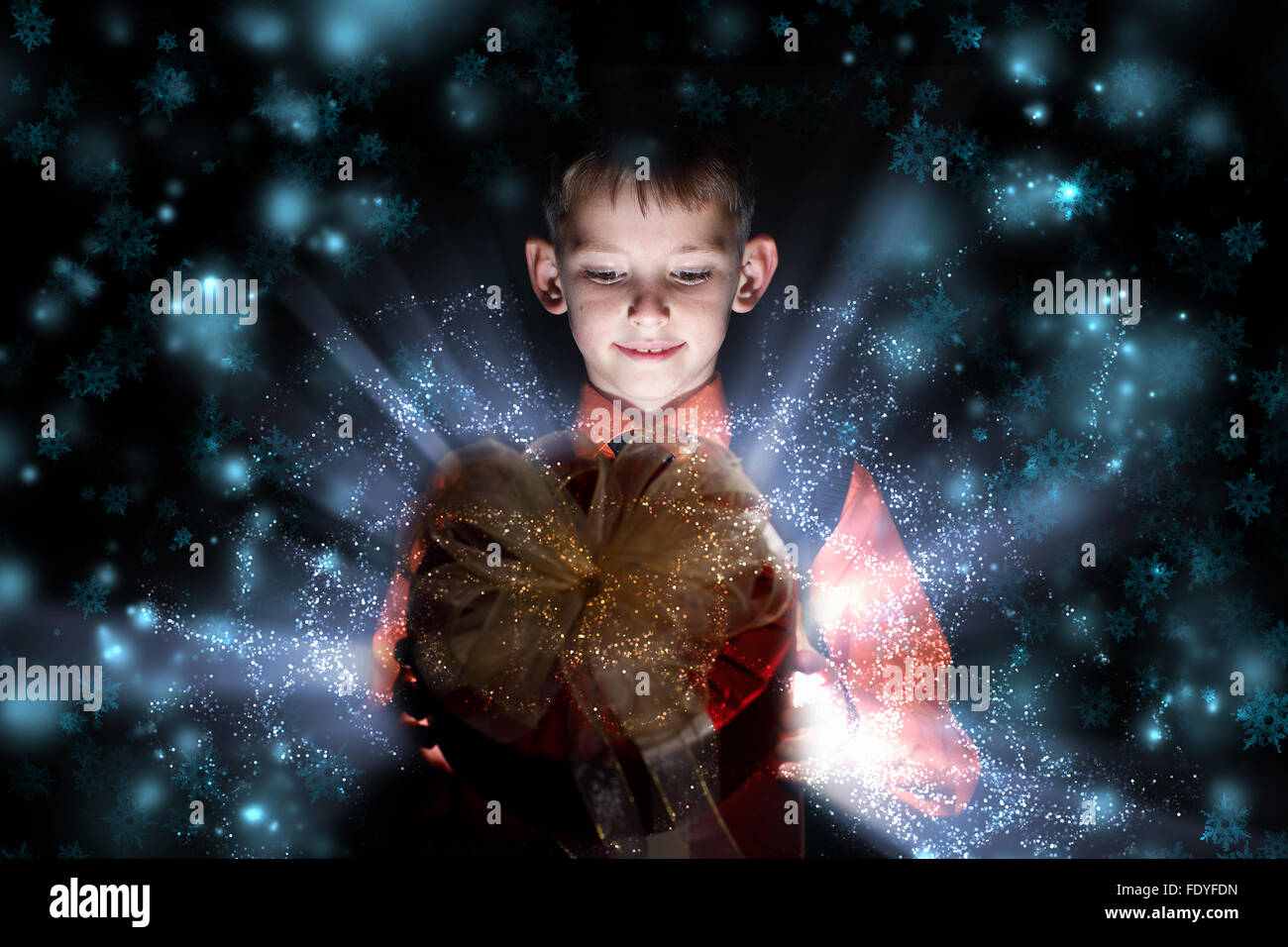 Child opening a magic gift box with lights and shining around Stock ...