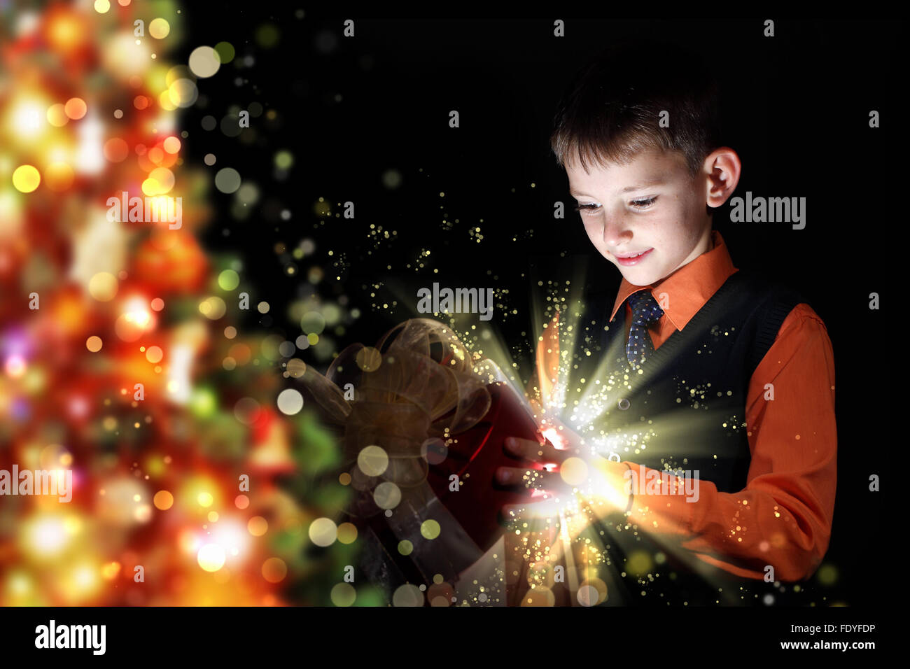 Child opening a magic gift box with lights and shining around Stock ...