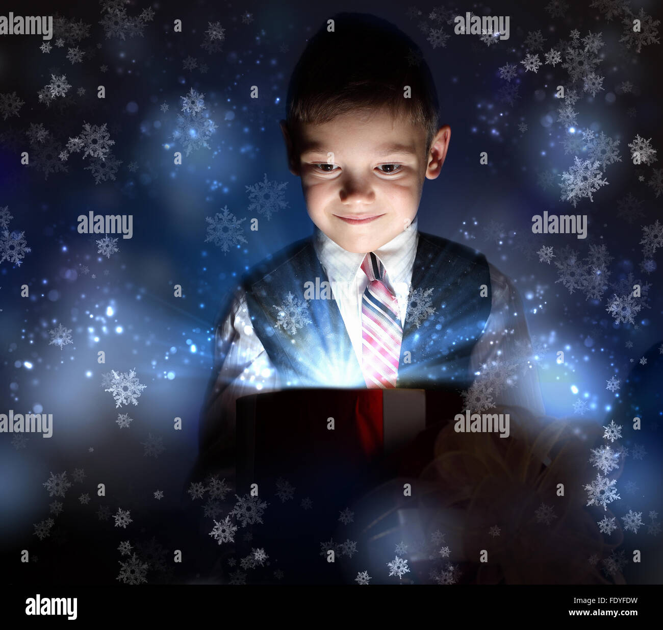 Child opening a magic gift box with lights and shining around Stock ...