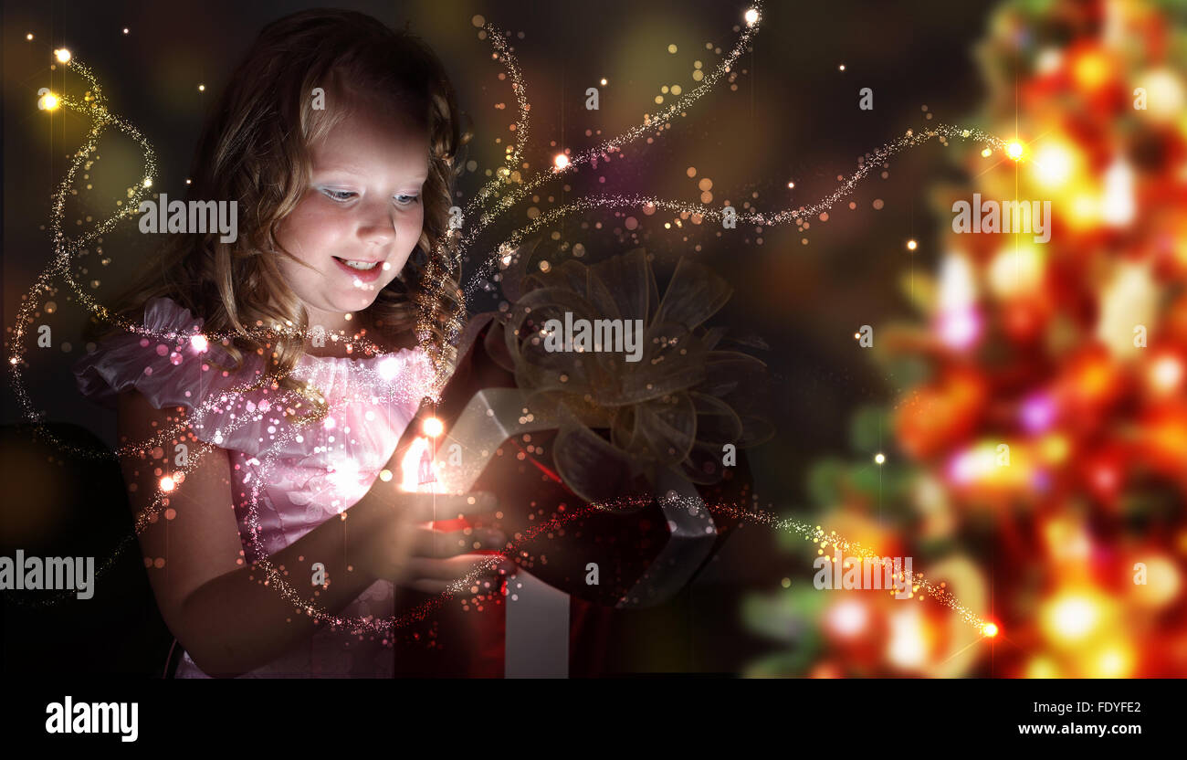 Child opening a magic gift box with lights and shining around Stock ...