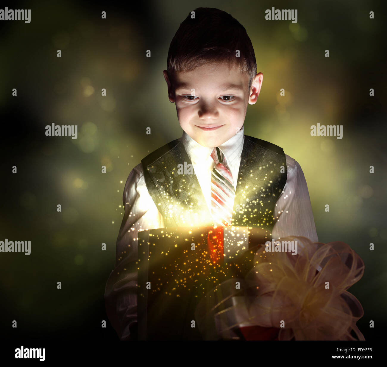 Child opening a magic gift box with lights and shining around Stock ...