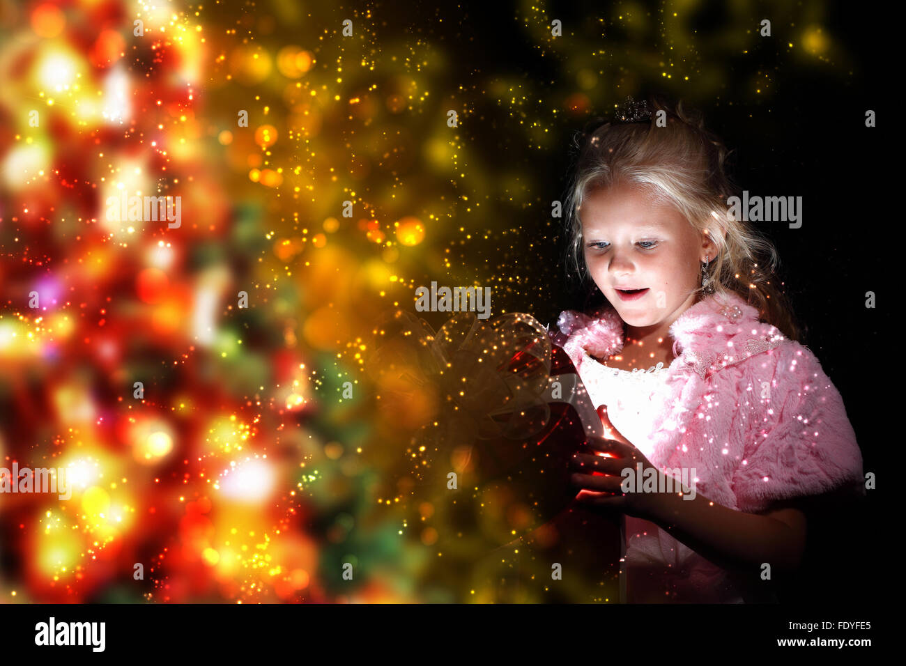 Child opening a magic gift box with lights and shining around Stock ...