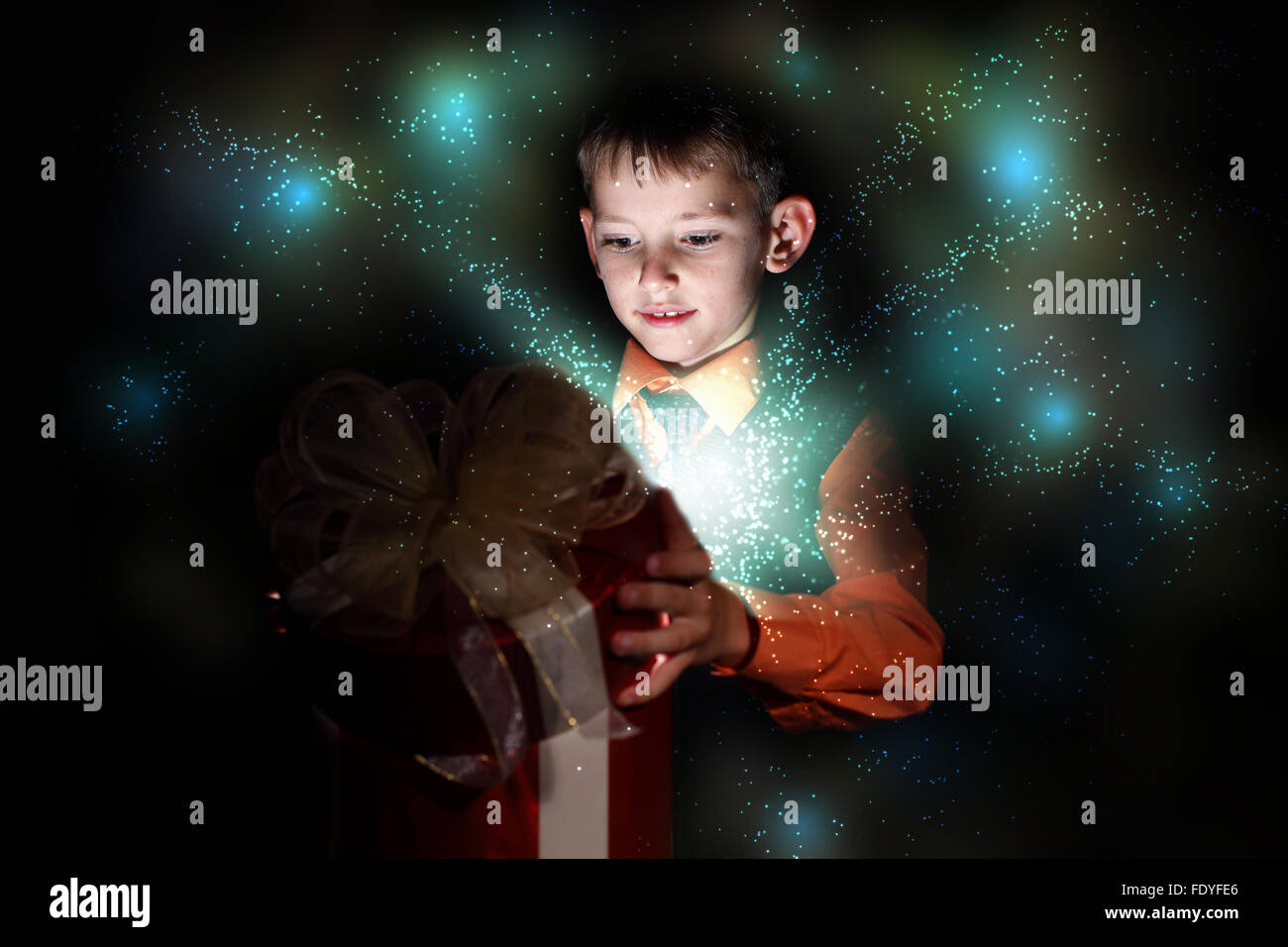 Child opening a magic gift box with lights and shining around Stock ...