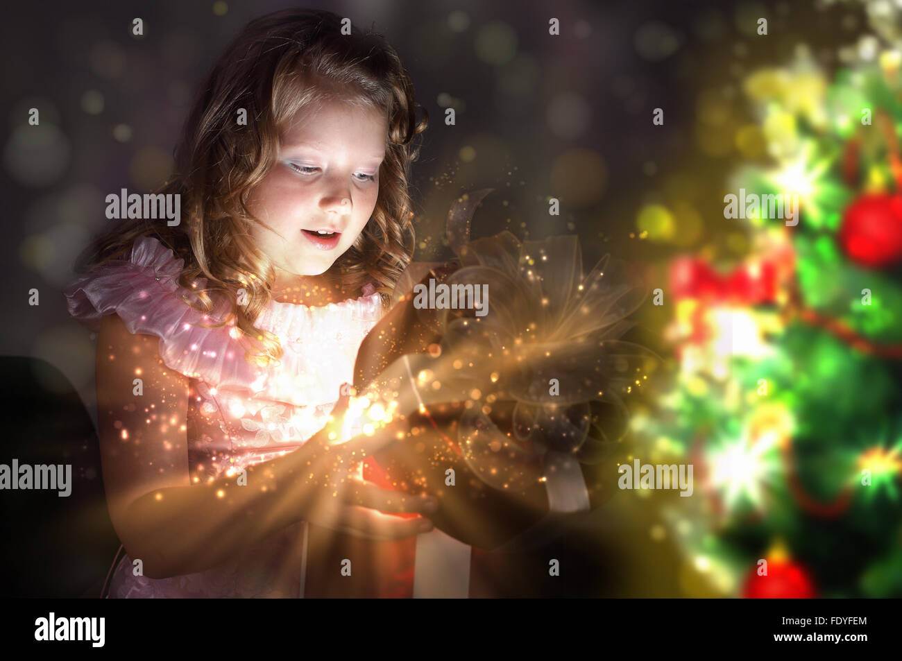 Child opening a magic gift box with lights and shining around Stock ...