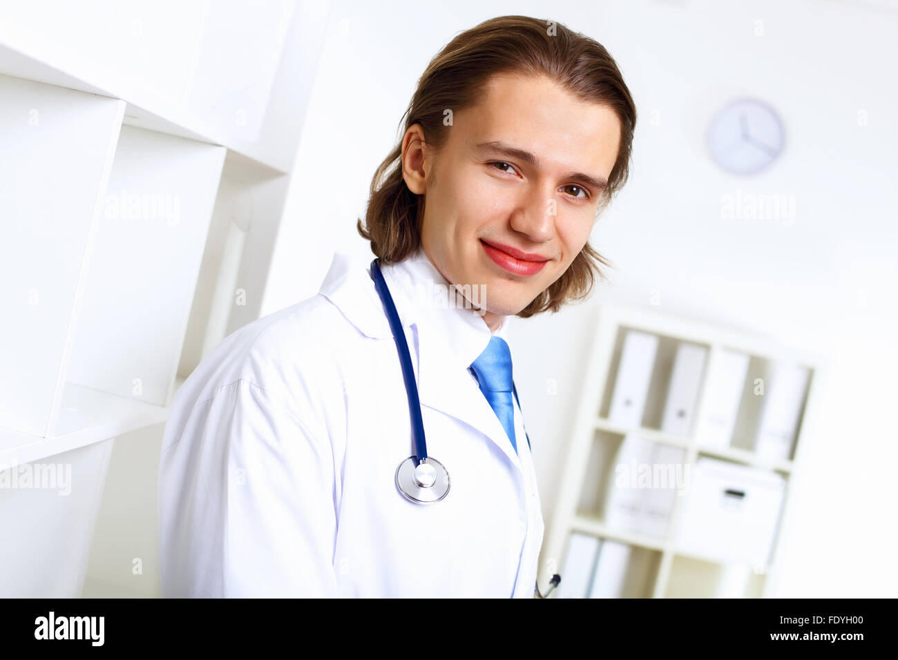 Young confident and friendly doctor in medical office Stock Photo - Alamy