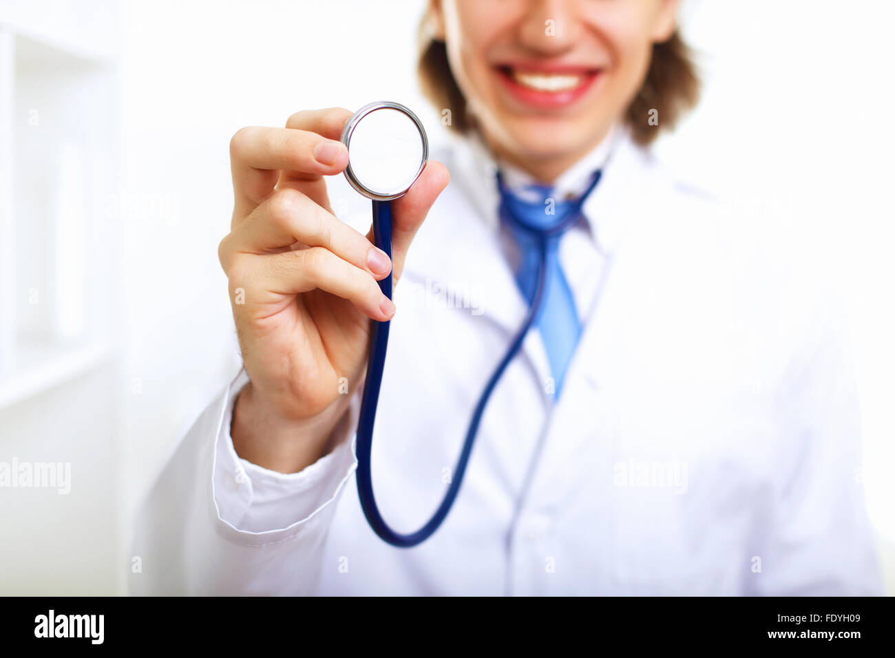 Young confident and friendly doctor in medical office Stock Photo - Alamy