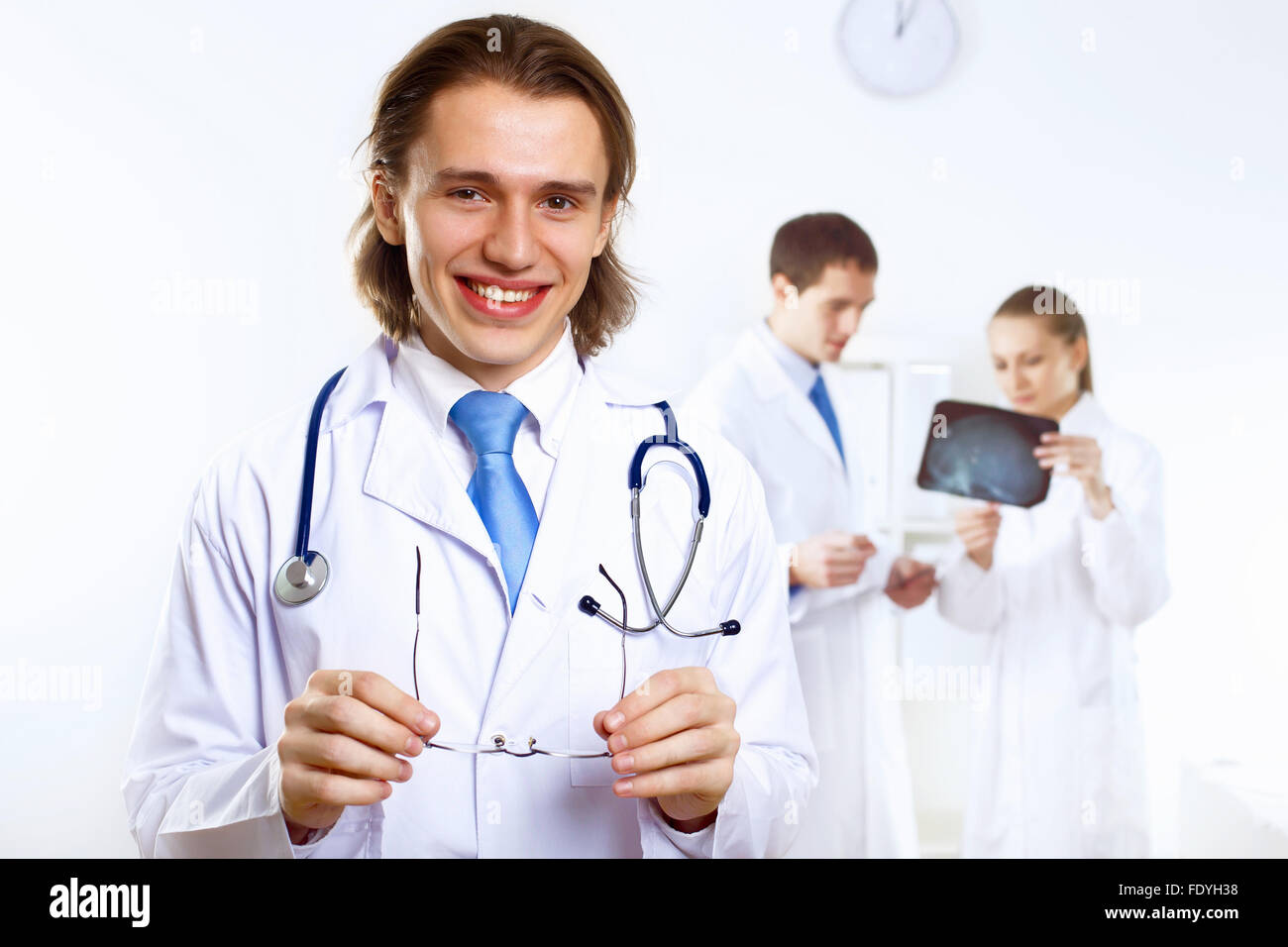 Young confident and friendly doctor in medical office Stock Photo - Alamy