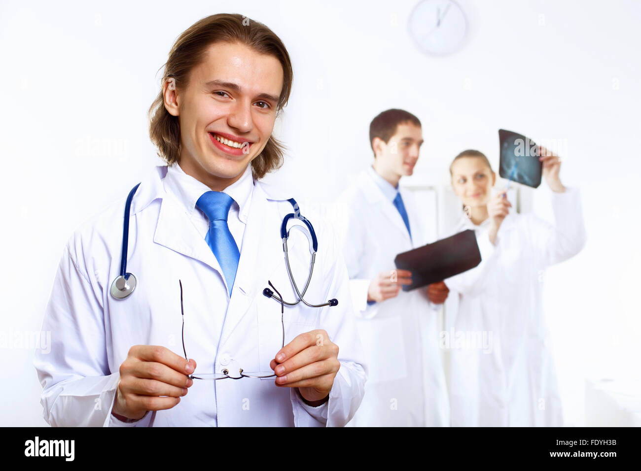 Young confident and friendly doctor in medical office Stock Photo - Alamy