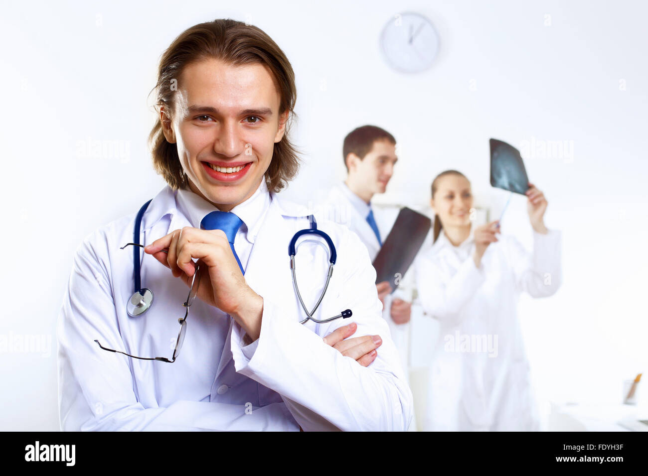 Young confident and friendly doctor in medical office Stock Photo - Alamy