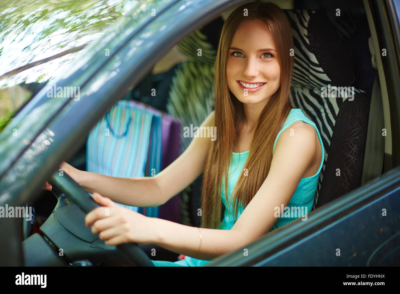 Beautiful girl sitting in car Stock Photo - Alamy