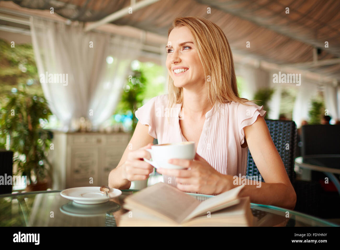 Beautiful girl sitting in cafe and having coffee Stock Photo - Alamy