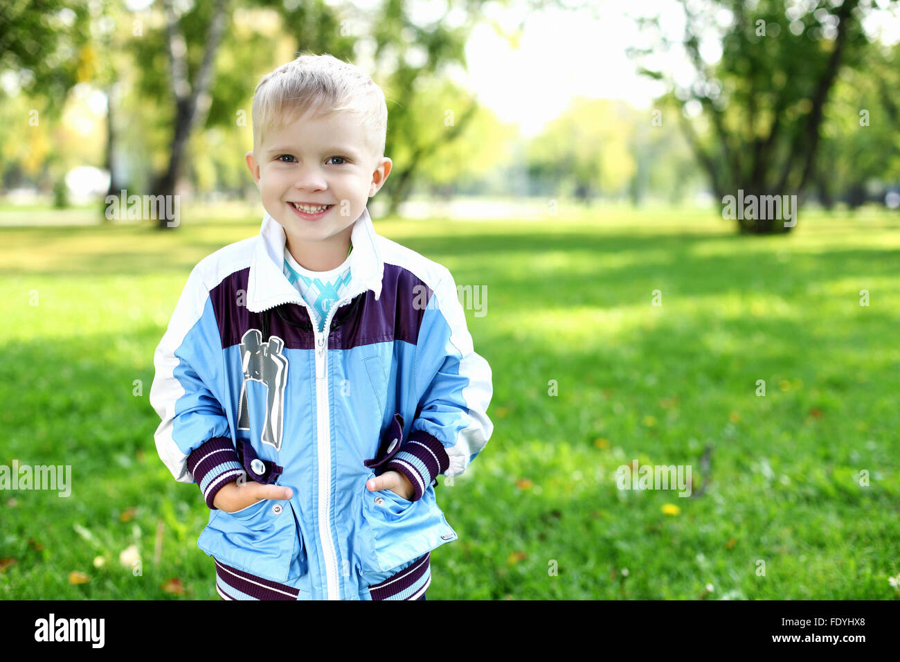 Happy little boy having fun in green summer park Stock Photo - Alamy