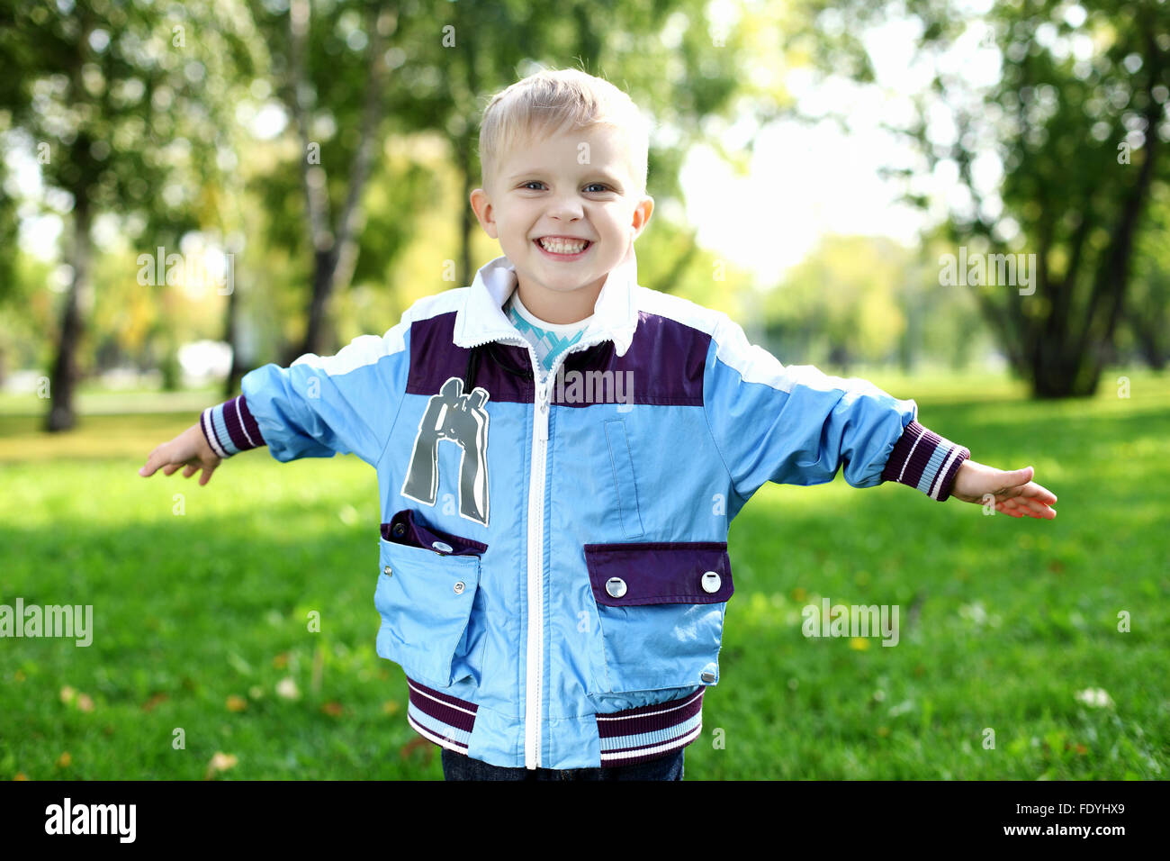 Happy little boy having fun in green summer park Stock Photo - Alamy