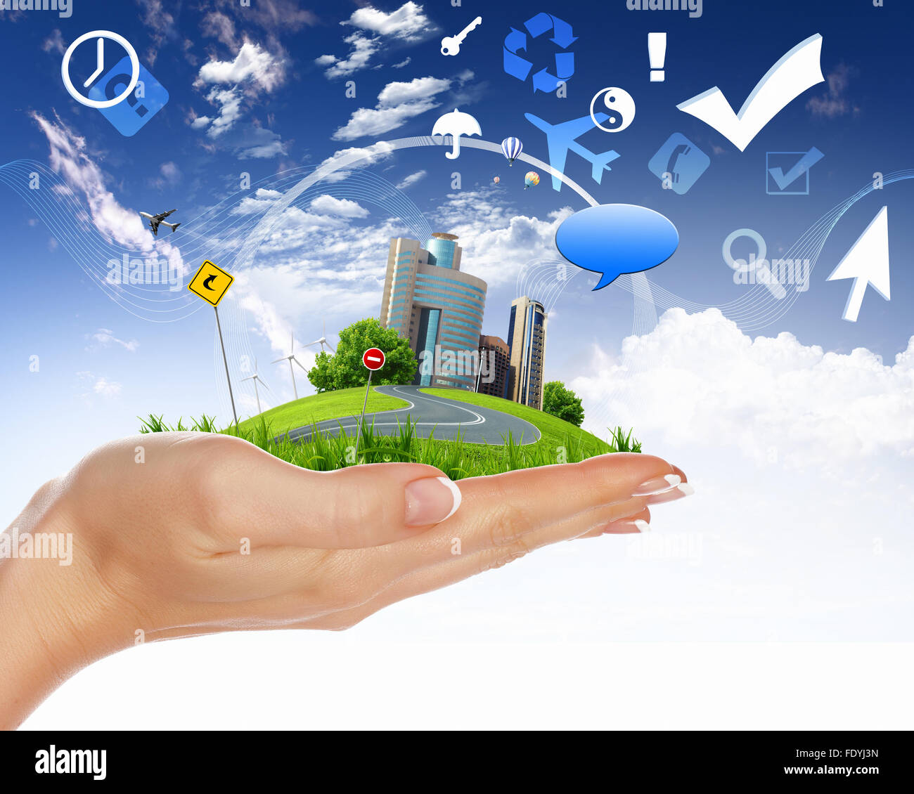 human hand holding a city on green grass hill Stock Photo - Alamy