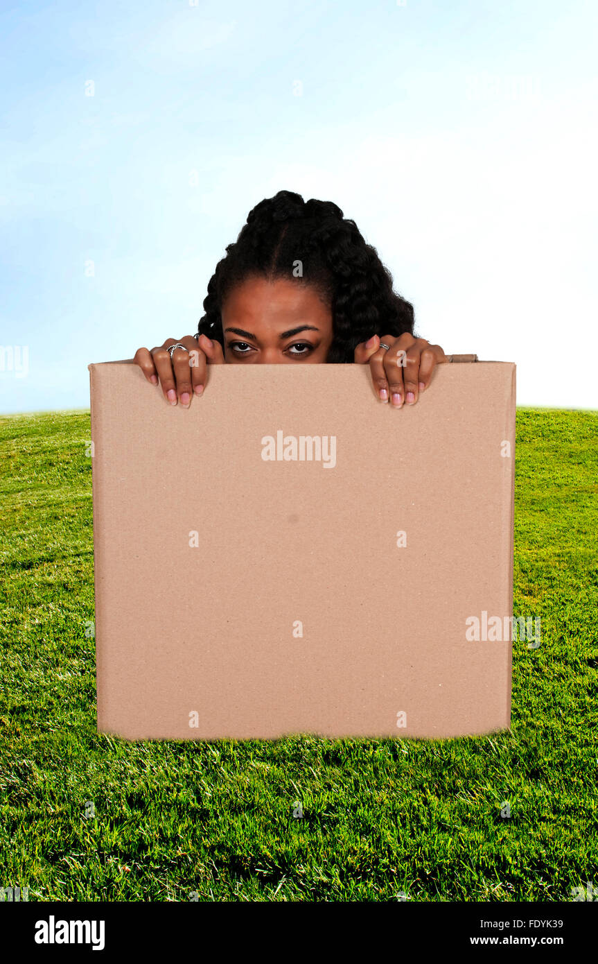 Beautiful woman thinking outside of the box Stock Photo - Alamy