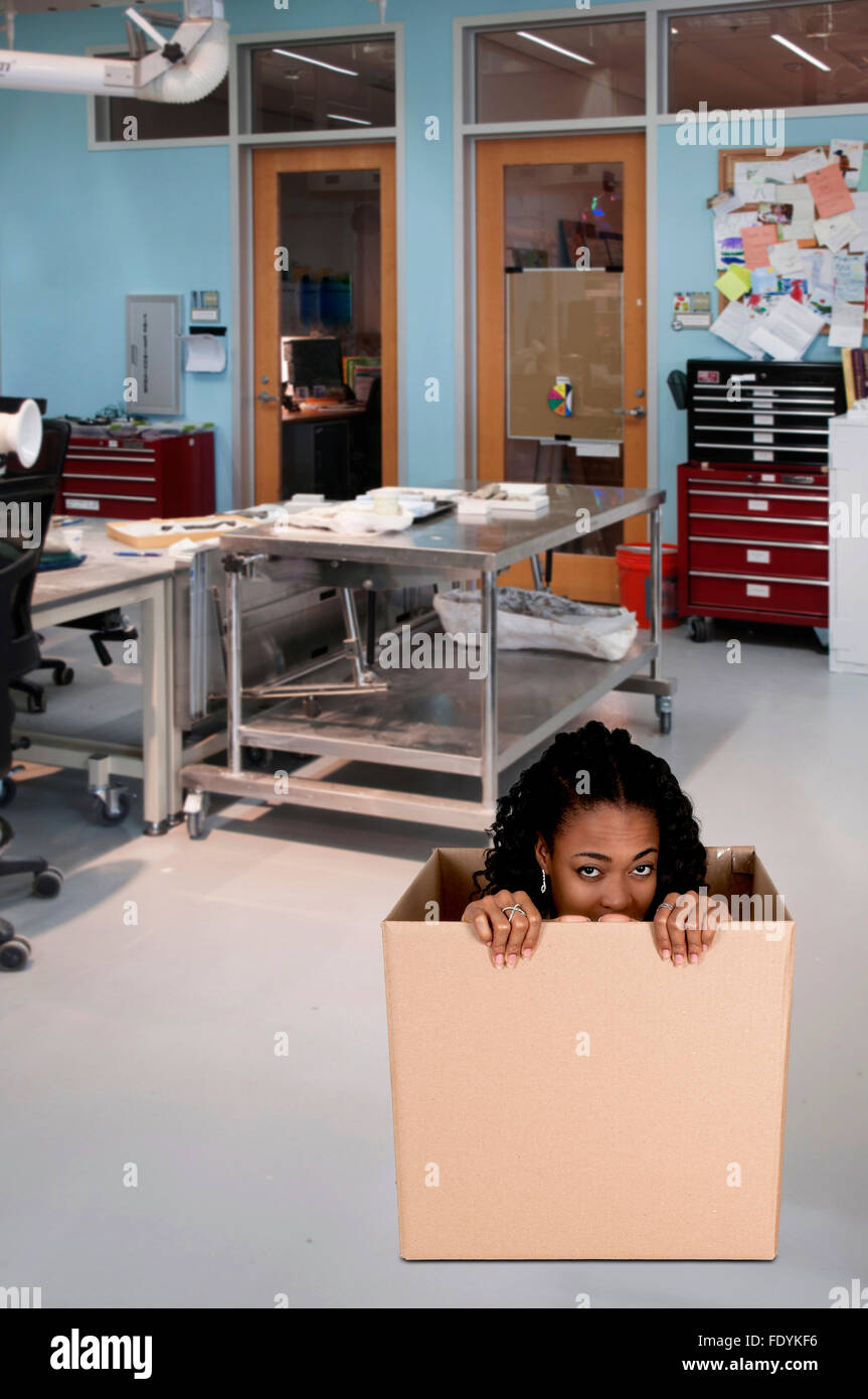 Beautiful black woman thinking while standing beside a box Stock Photo ...