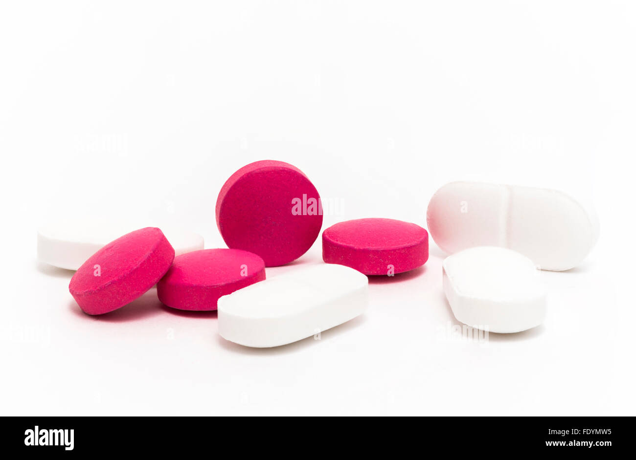 Pink and white pills isolated on white background Stock Photo - Alamy