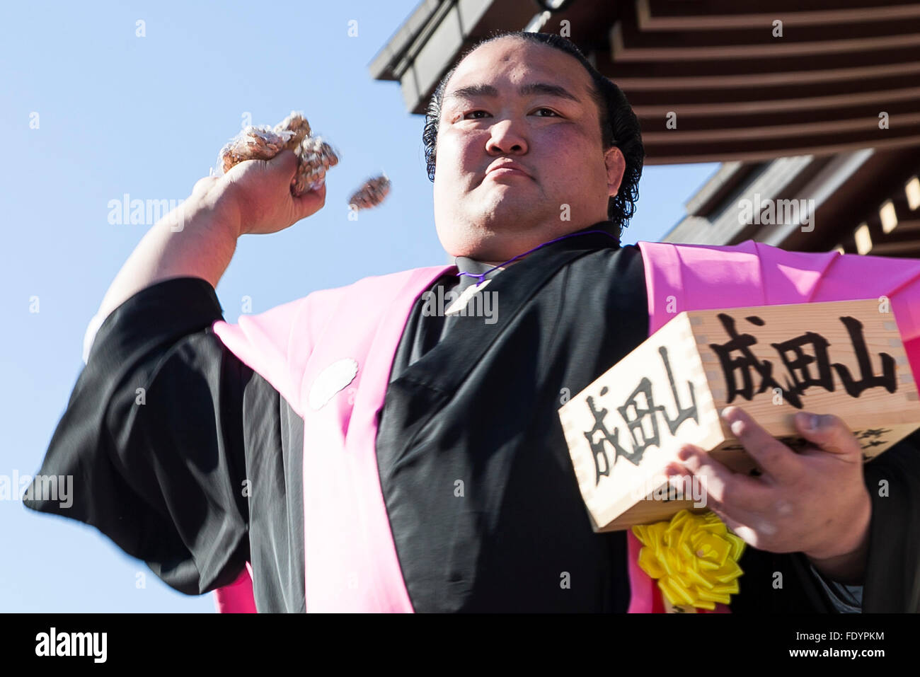 Sumo wrestler Ozeki Kisenosato throws beans during a Setsubun festival ...