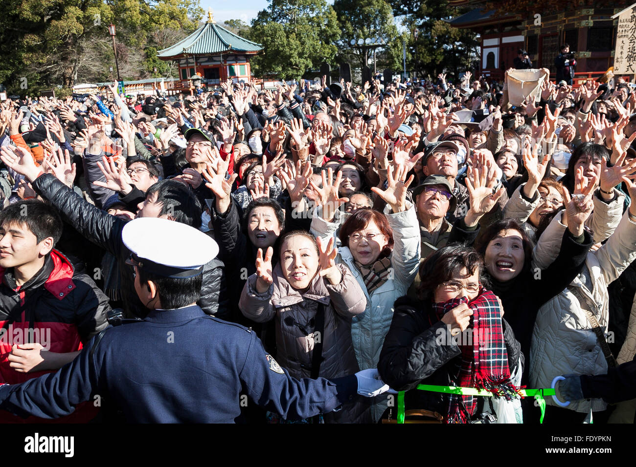 Visitors scramble to collect beans from Sumo wrestlers during a ...