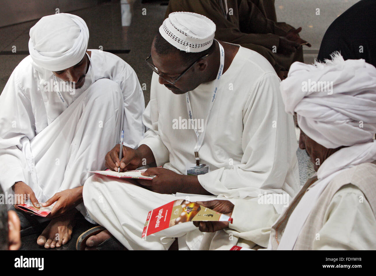 Dubai, United Arab Emirates, Men in traditional costume sitting on the ...