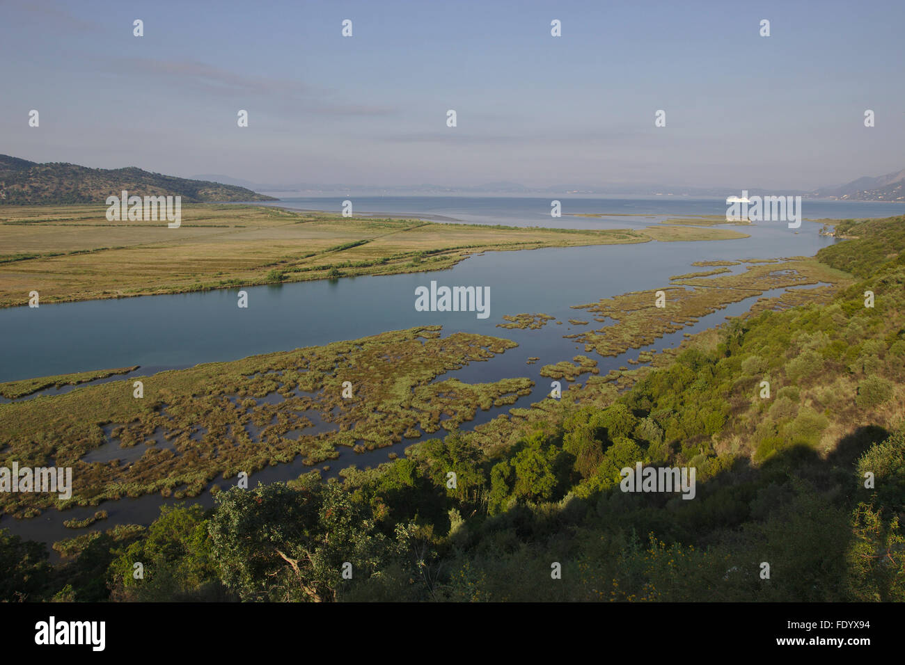 Canal connecting the Butrint lagoon with the Adriatic Sea, evening ...