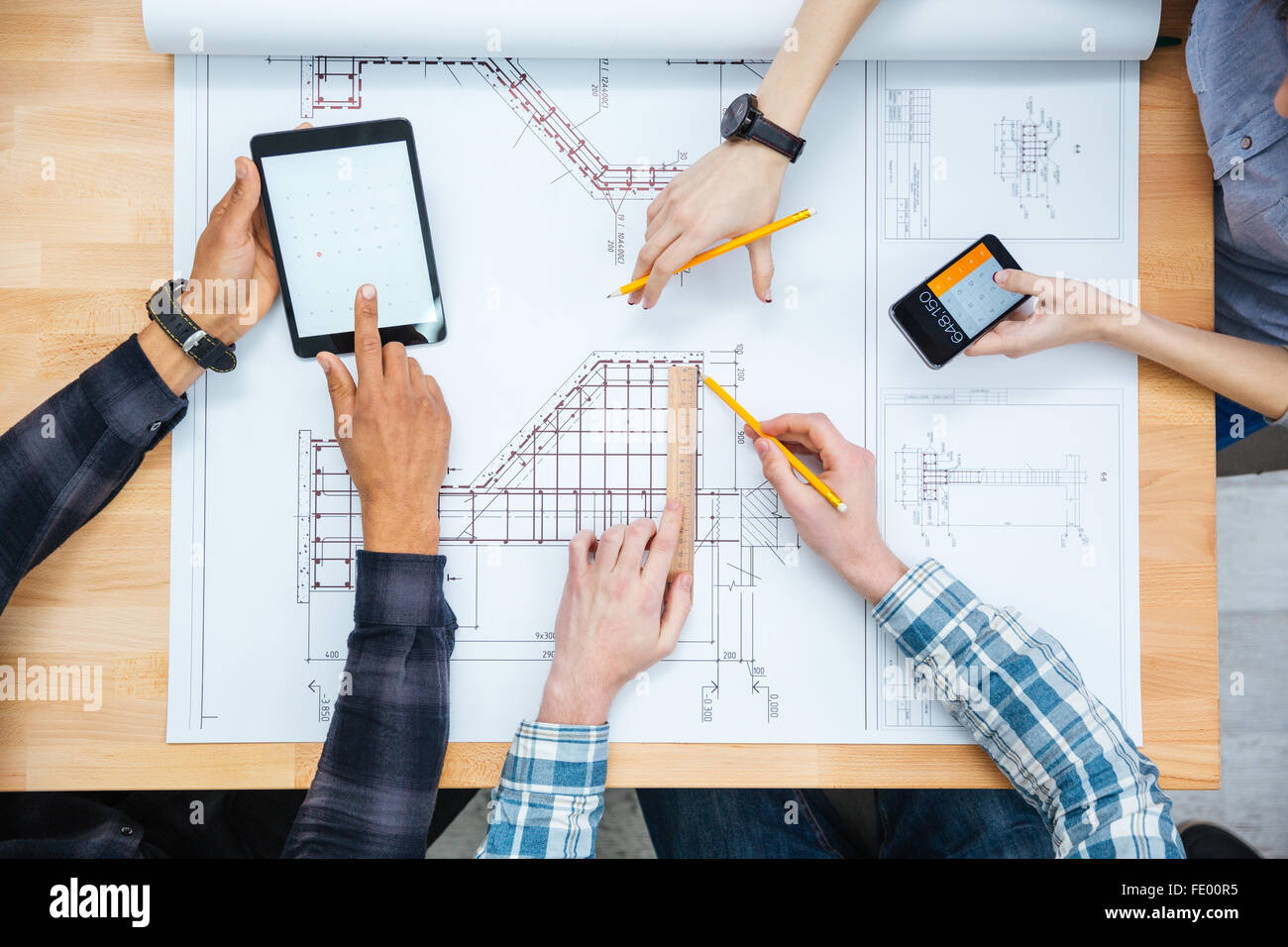 Multiethnic group of designers making calculations and working with ...