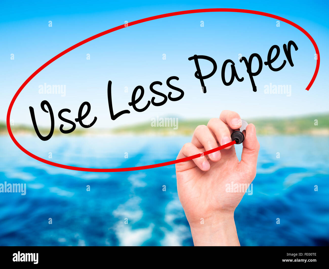 Man Hand writing Use Less Paper with black marker on visual screen ...