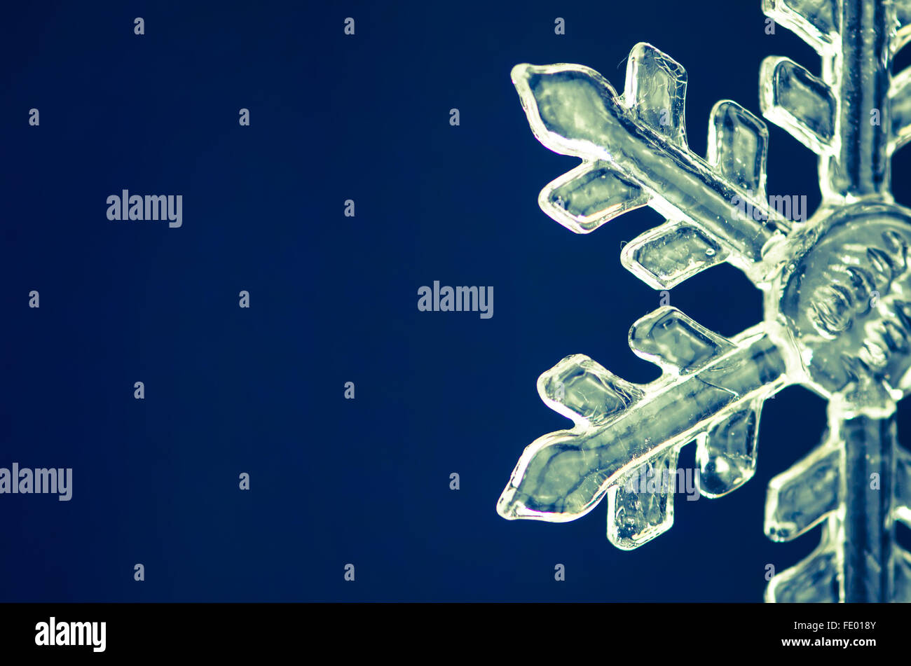 crystal snowflake decoration against blue background Stock Photo - Alamy