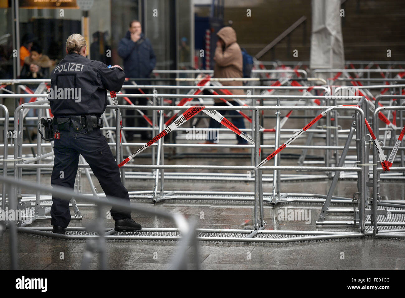 Police officers set up security barricades on the plaza in front of the ...