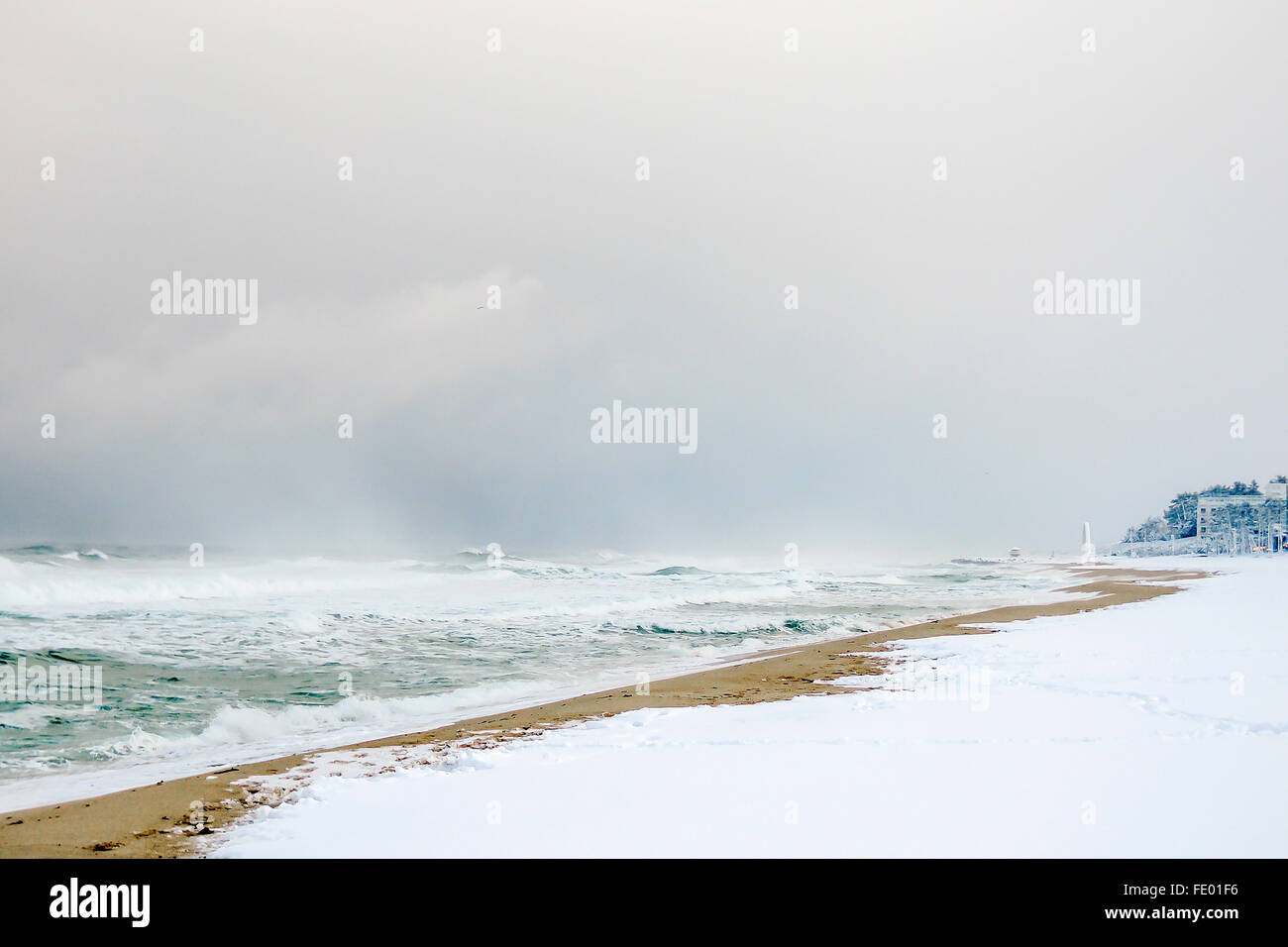 Snow on the beach on a windy winter's day Stock Photo - Alamy