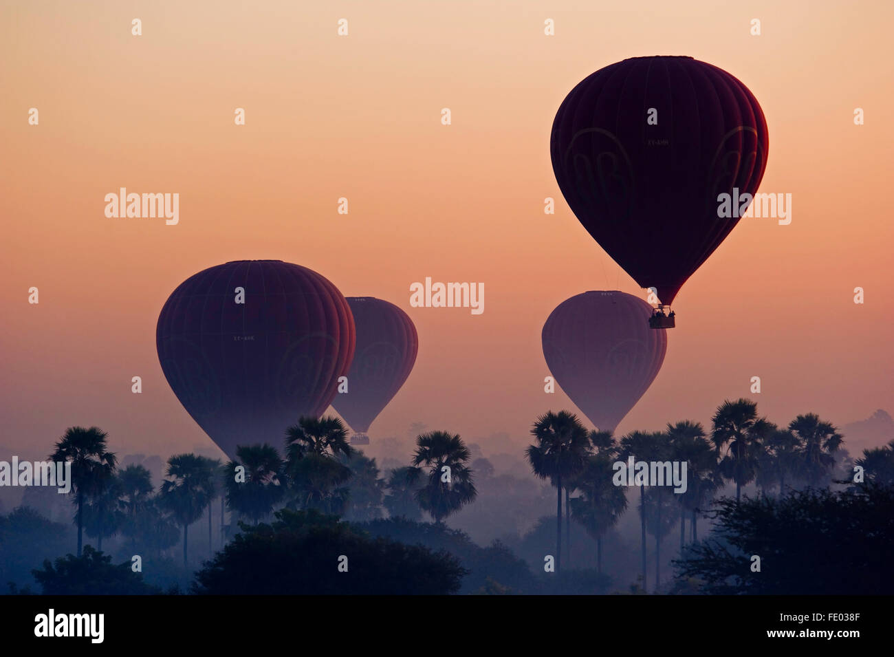 Hot air balloons in the mist at sunrise, Bagan, Myanmar Stock Photo - Alamy
