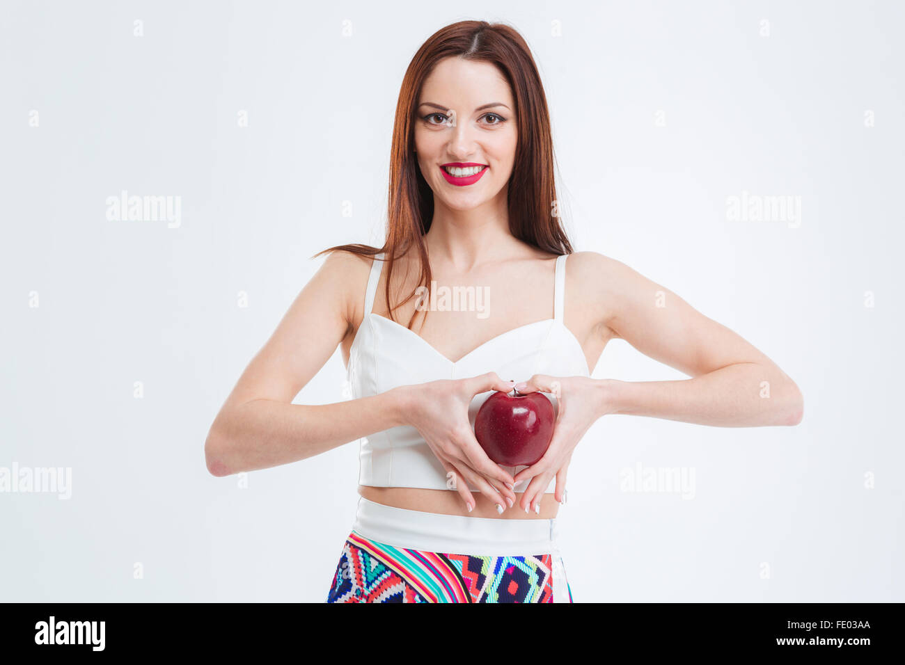 Happy attractive woman posing with red apple isolated on a white ...
