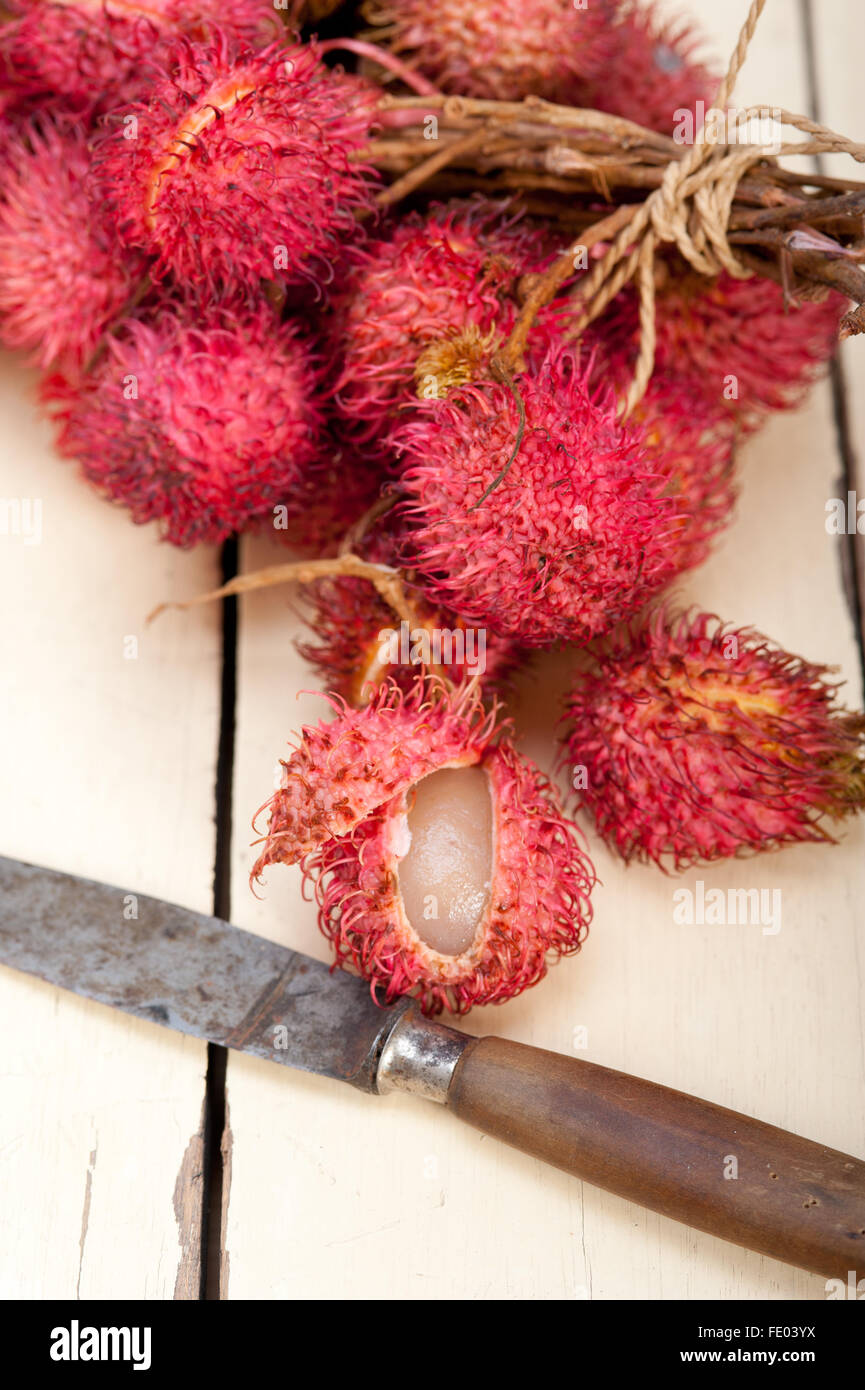fresh tropical rambutan fruits over rustic wood table Stock Photo - Alamy