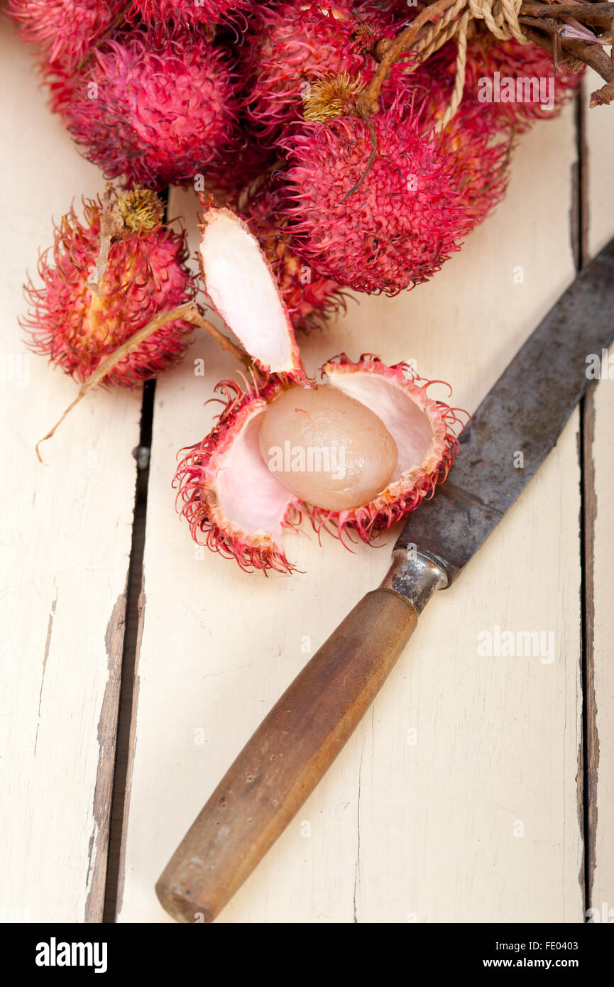 fresh tropical rambutan fruits over rustic wood table Stock Photo - Alamy