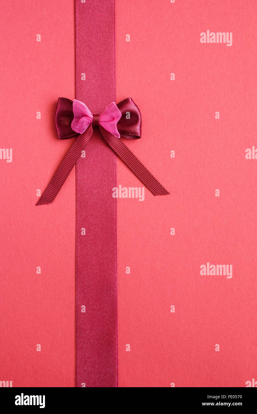 Red satin ribbon on the paper background Stock Photo - Alamy