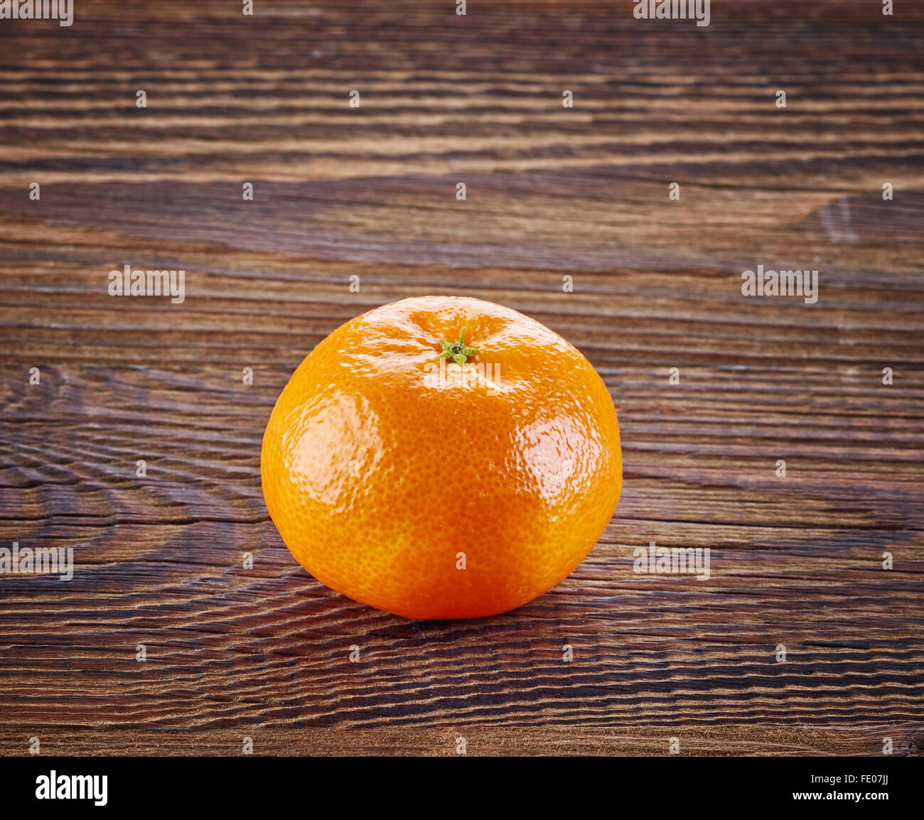 Mandarin orange or tangerine on brown wooden table Stock Photo - Alamy