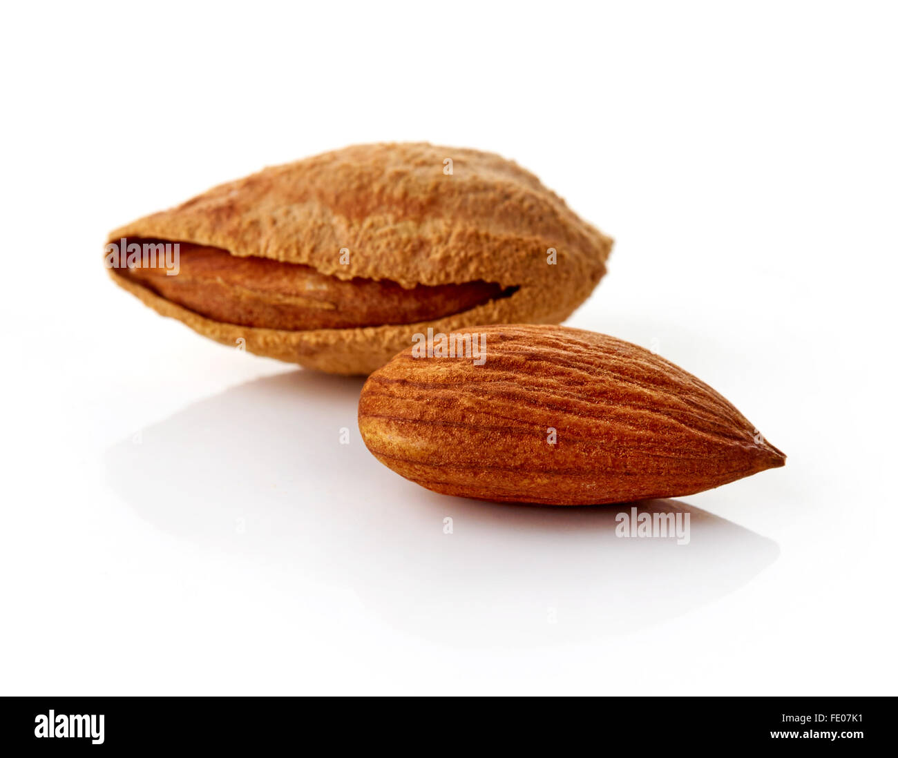 Almond in cracked shell and almond on white background Stock Photo - Alamy