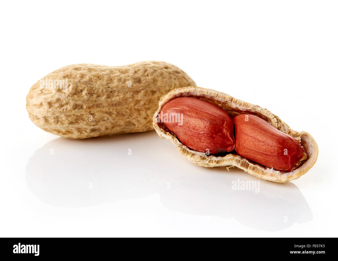 Cracked peanuts on white background Stock Photo - Alamy